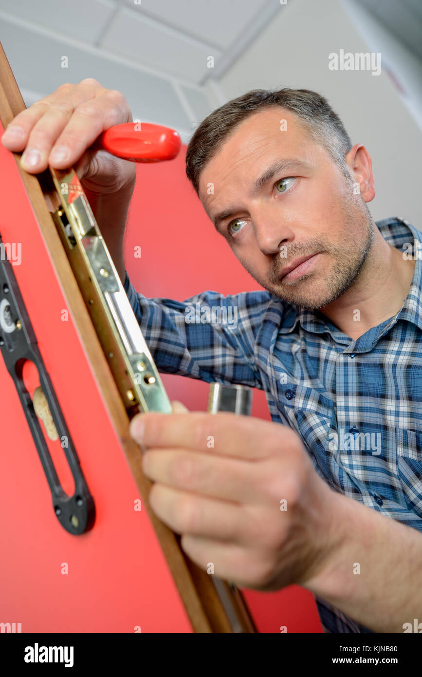 man fixing door lock Stock Photo - Alamy