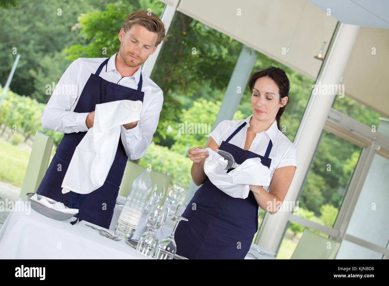 2 waiters setting up restaurant tables Stock Photo - Alamy