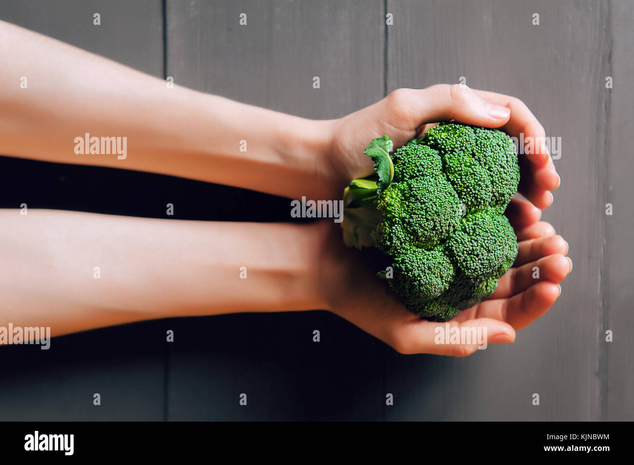 broccoli in hands. a wooden background. healthy eating concept Stock ...
