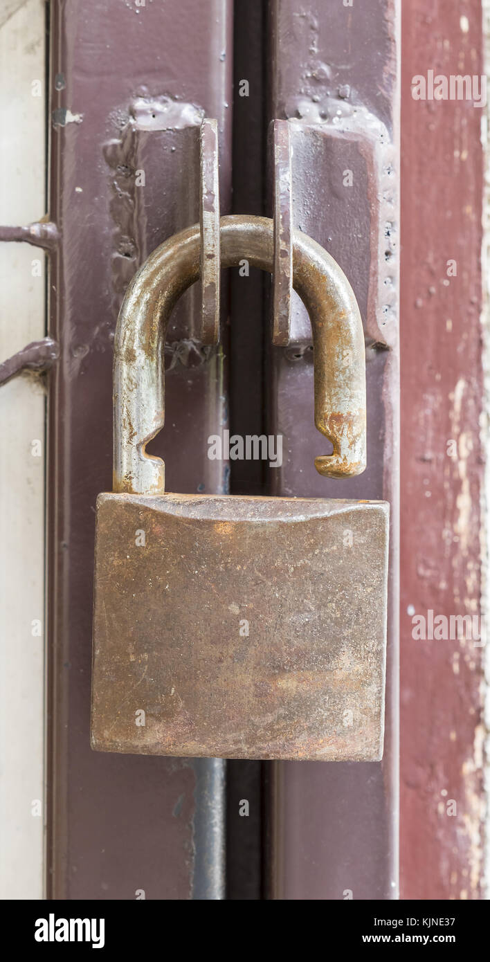 Brass padlock hook on door loop - unlocked status Stock Photo - Alamy