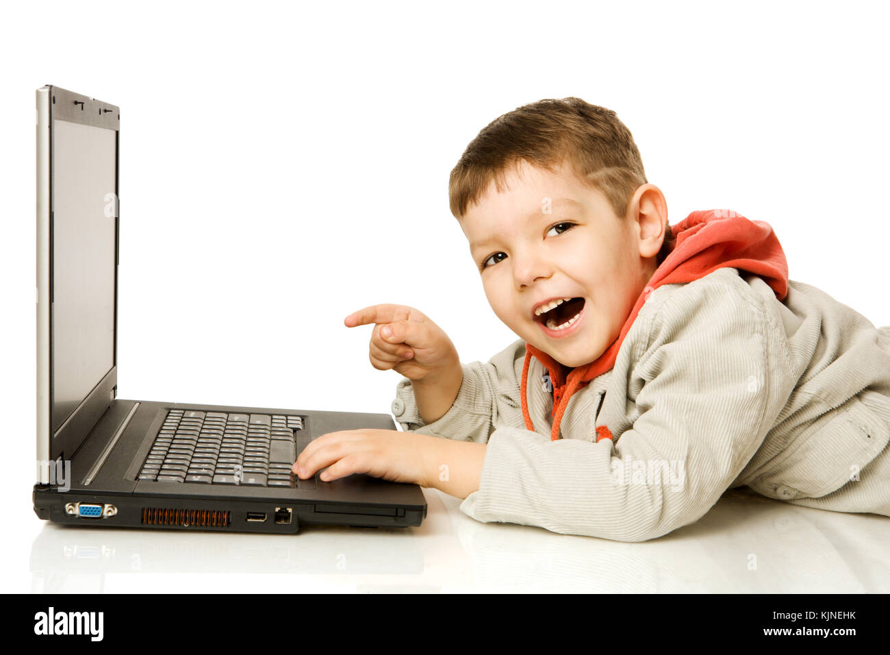 Boy typing on laptop and laughing isolated on white Stock Photo - Alamy