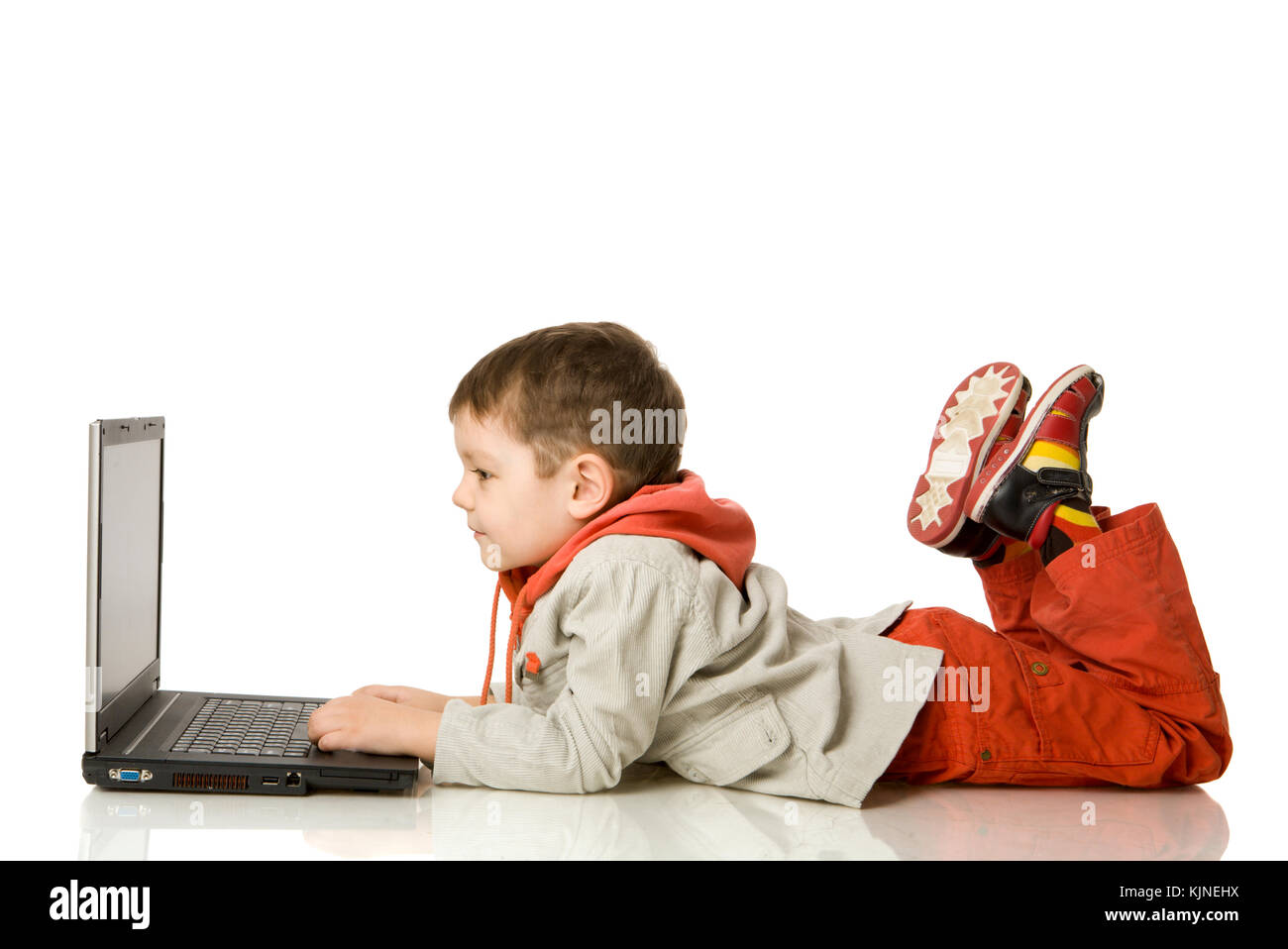 Boy typing on laptop and laughing isolated on white Stock Photo - Alamy