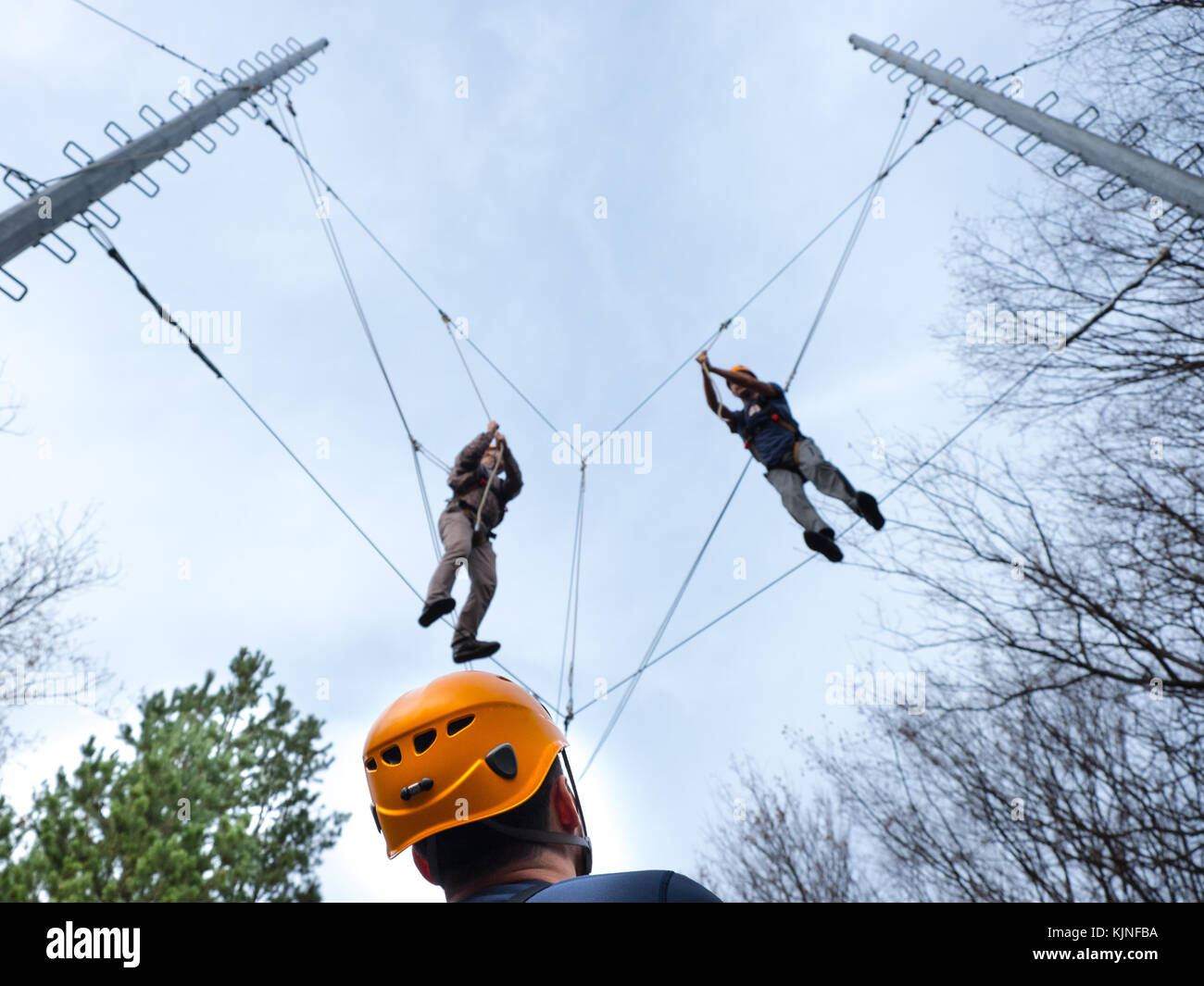 men at adventure climbing park walks by a rope simulator Stock Photo ...