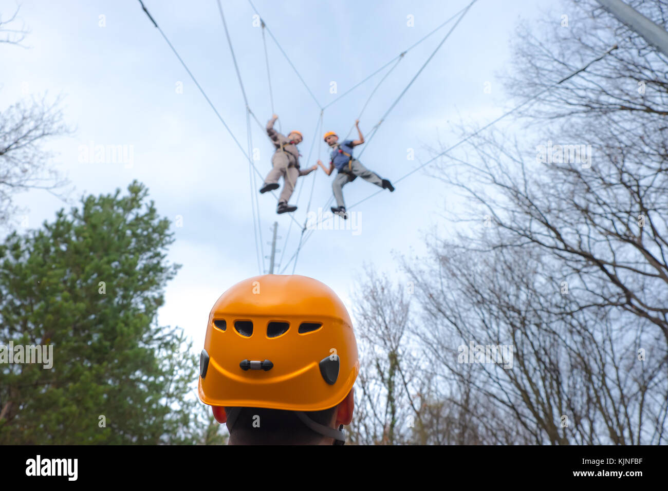 men at adventure climbing park walks by a rope simulator Stock Photo ...