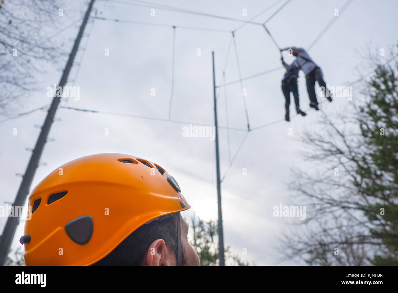 men at adventure climbing park walks by a rope simulator Stock Photo ...