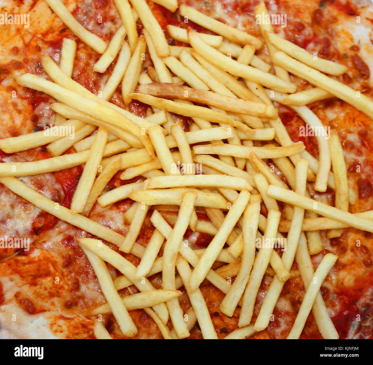 lots of french fries over tasty takeaway pizza Stock Photo - Alamy