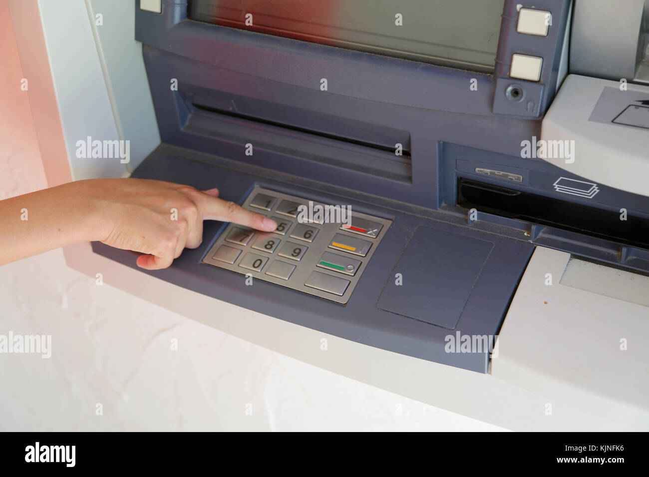hand of girl type the secret code in the ATM's keyboard to pick up the ...