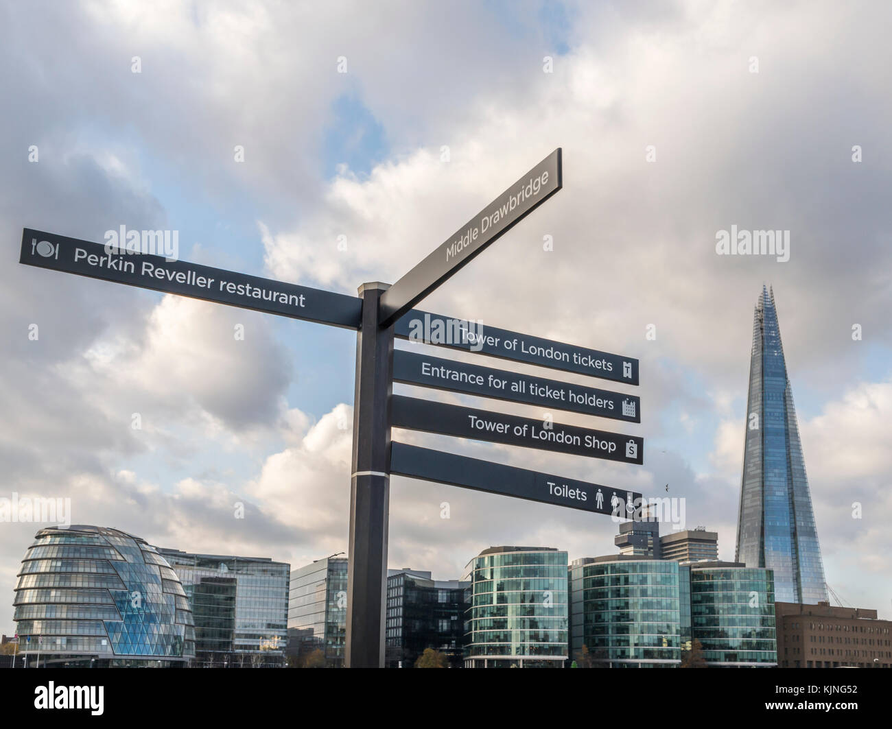 Sign posts with major attractions near Tower HIll in London with modern ...