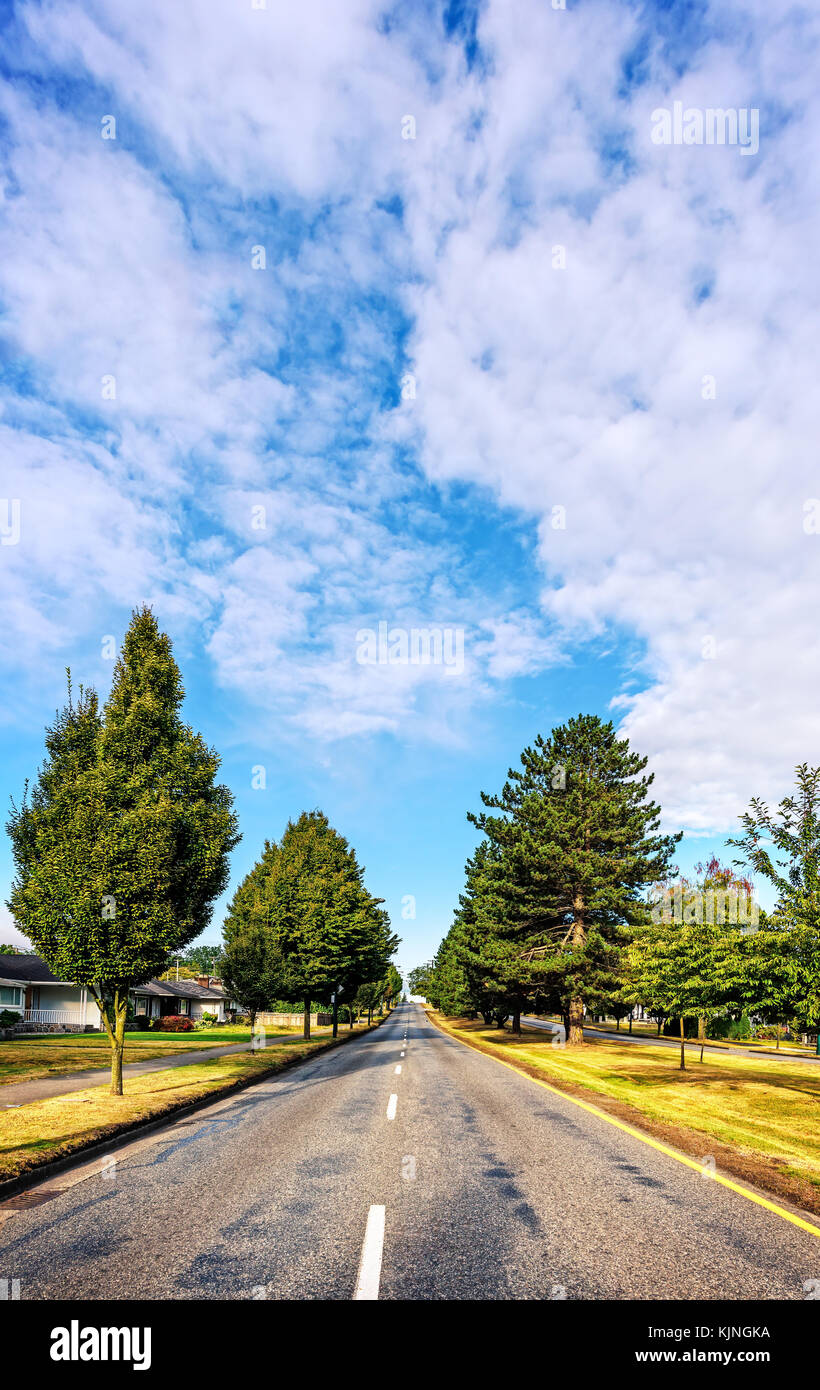 beautiful asphalt road in the suburbs with beautiful scenery, blue sky ...