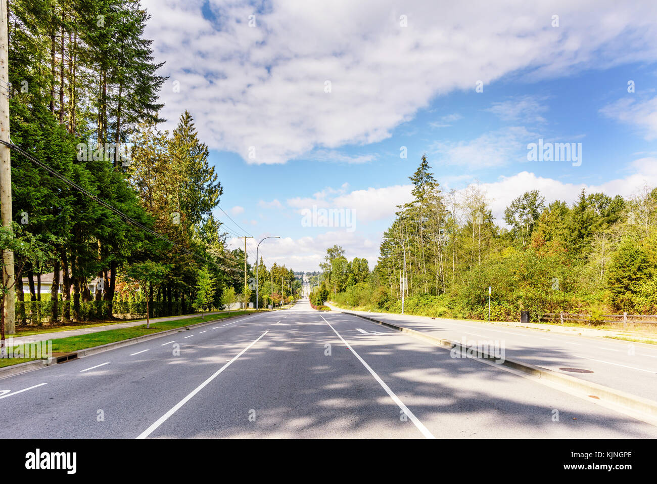 beautiful asphalt road in the suburbs with beautiful scenery, blue sky ...