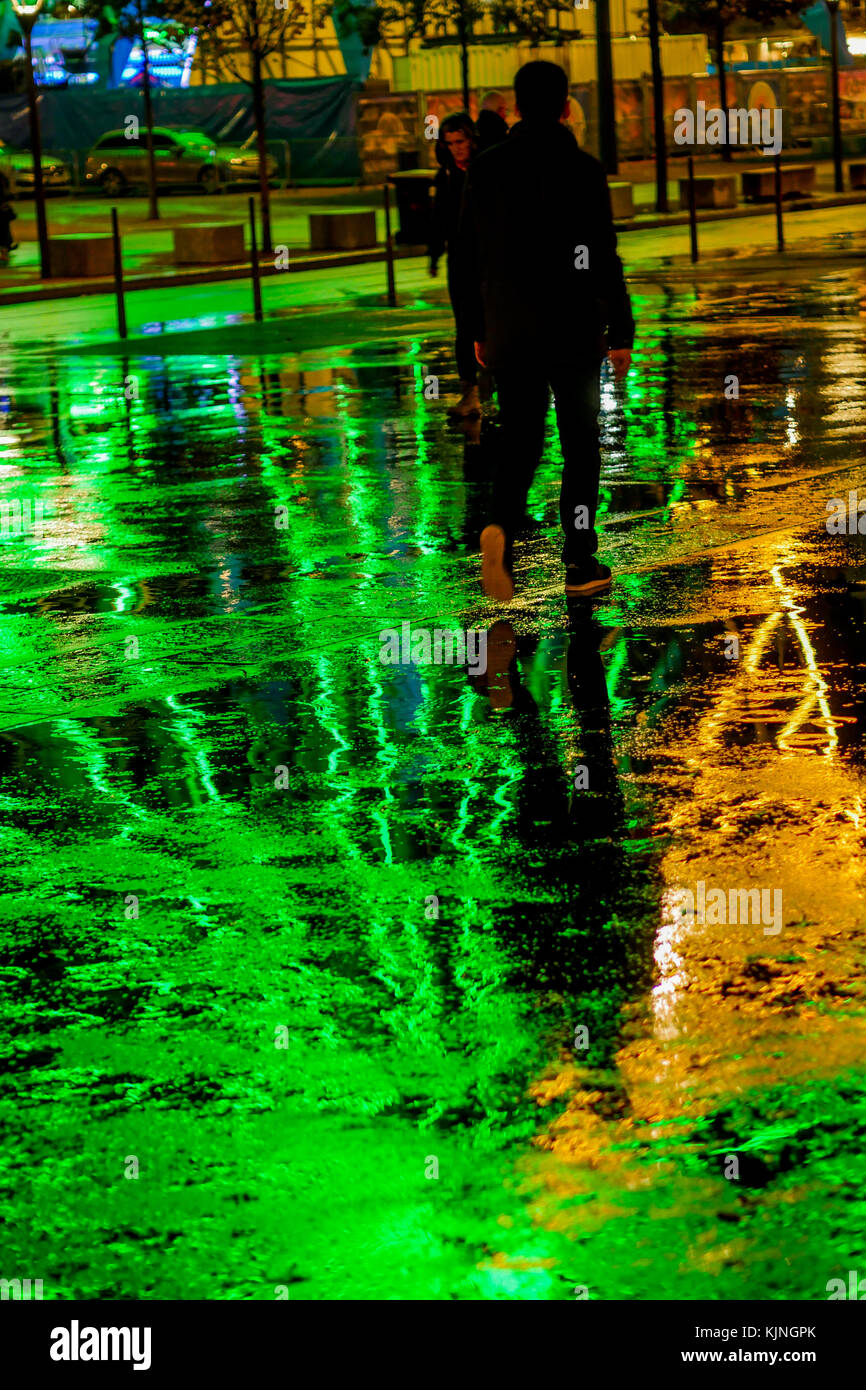 Traditional Ferris Wheel reflects on wet pavement, Lyon, France Stock ...