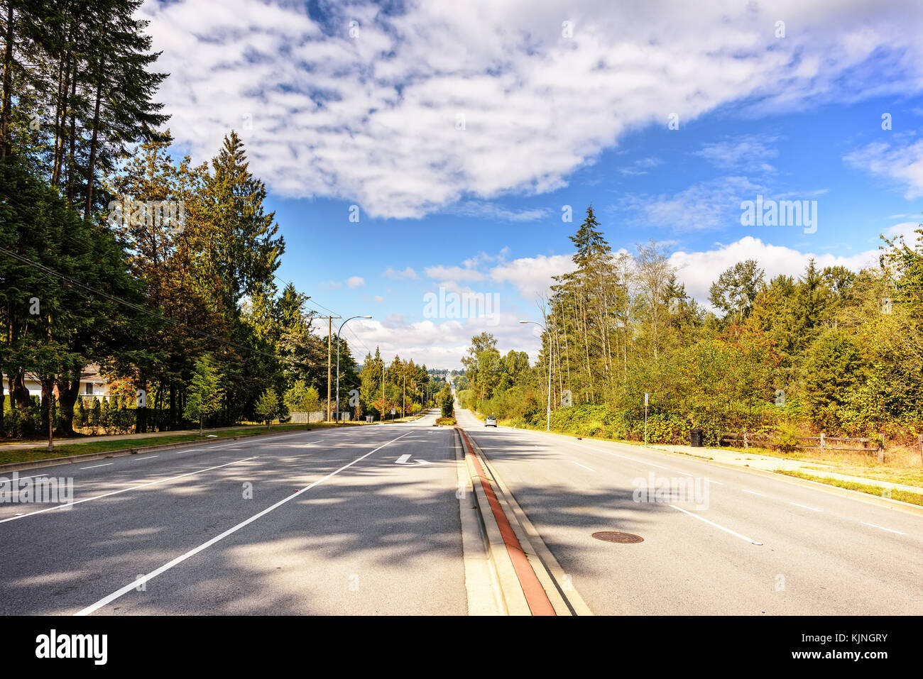 beautiful asphalt road in the suburbs with beautiful scenery, blue sky ...