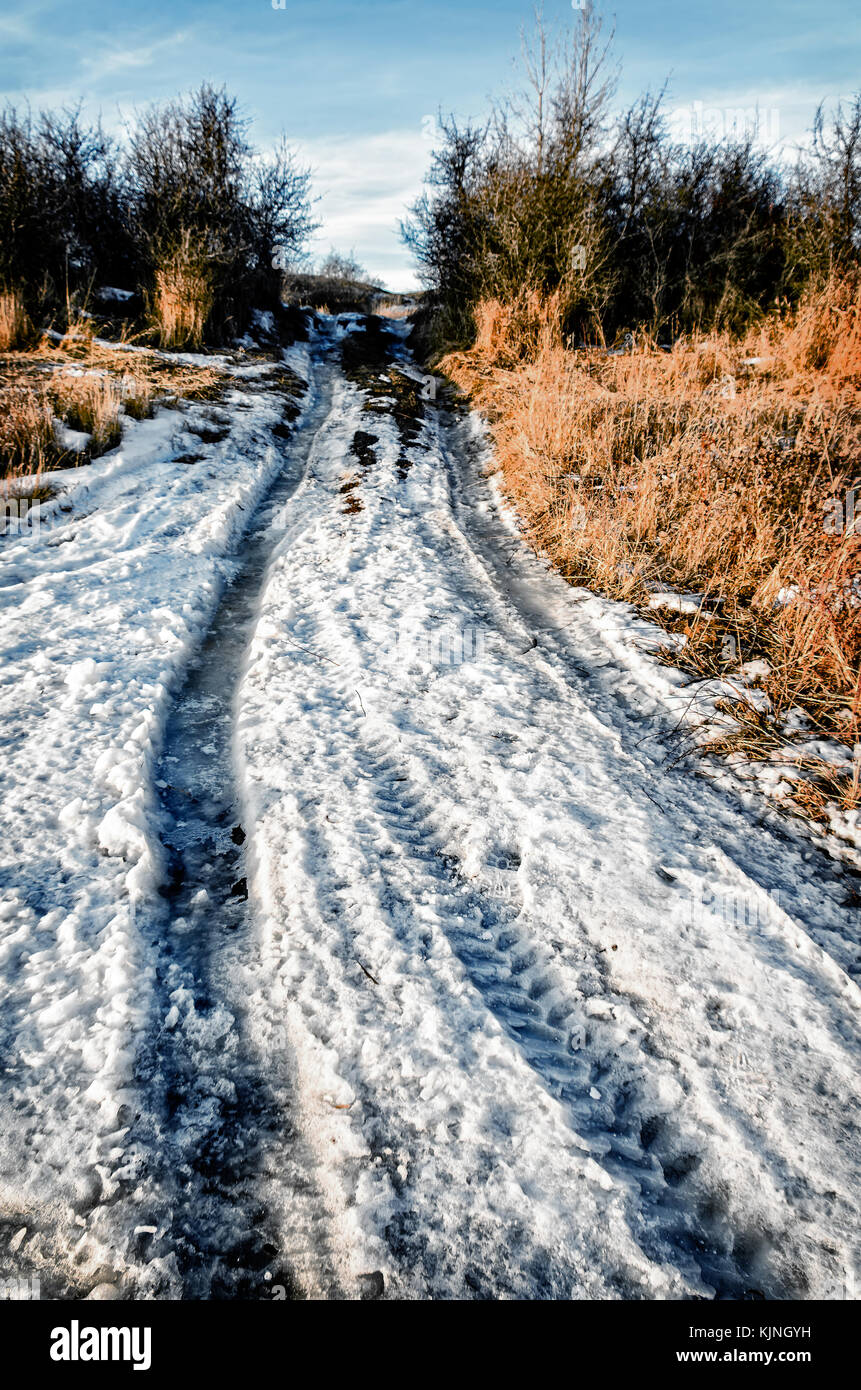 icy road that is difficult to traverse, a country road upwards with ...