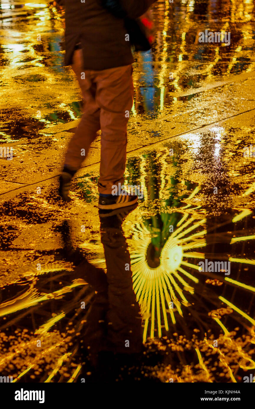 Traditional Ferris Wheel reflects on wet pavement, Lyon, France Stock ...