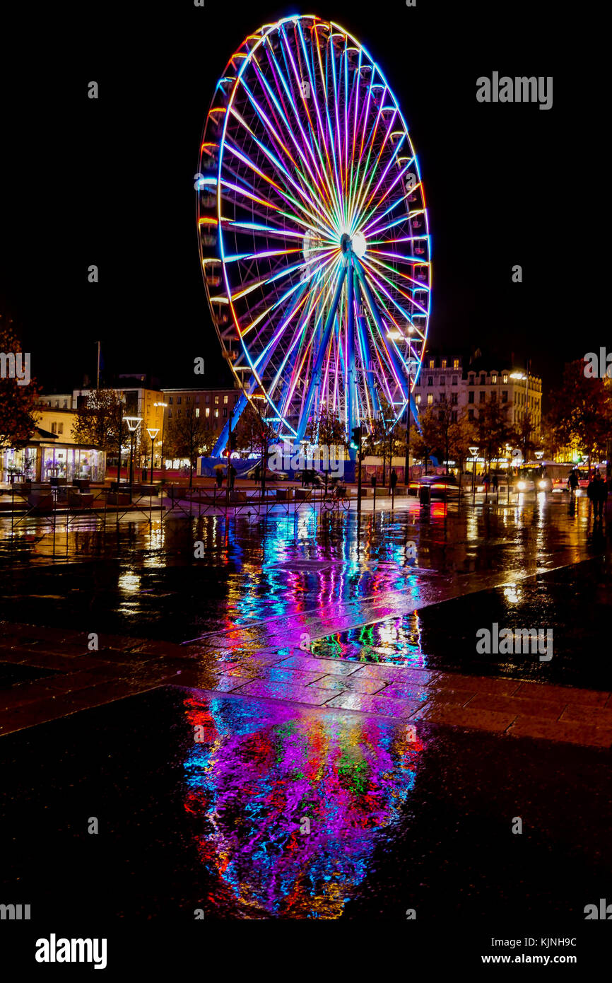 Traditional Ferris Wheel glows in Christmas lights, Lyon, France Stock ...
