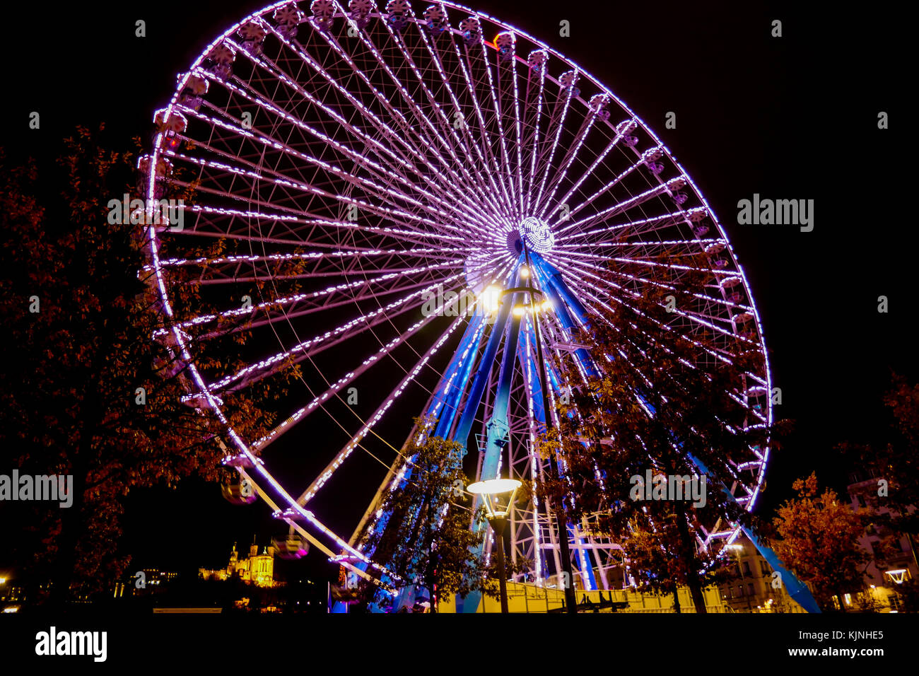 Traditional Ferris Wheel glows in Christmas lights, Lyon, France Stock ...