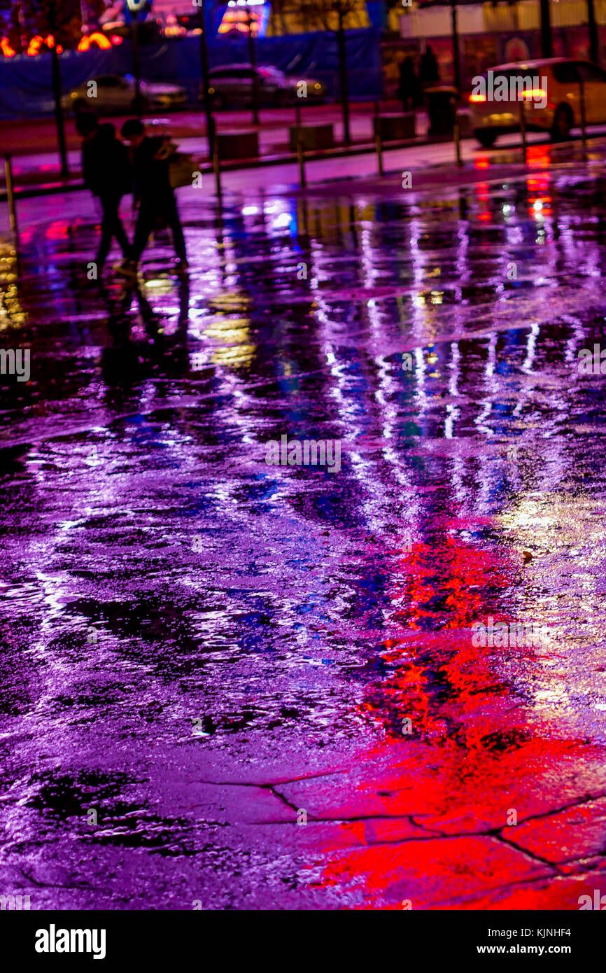 Traditional Ferris Wheel reflects on wet pavement, Lyon, France Stock ...