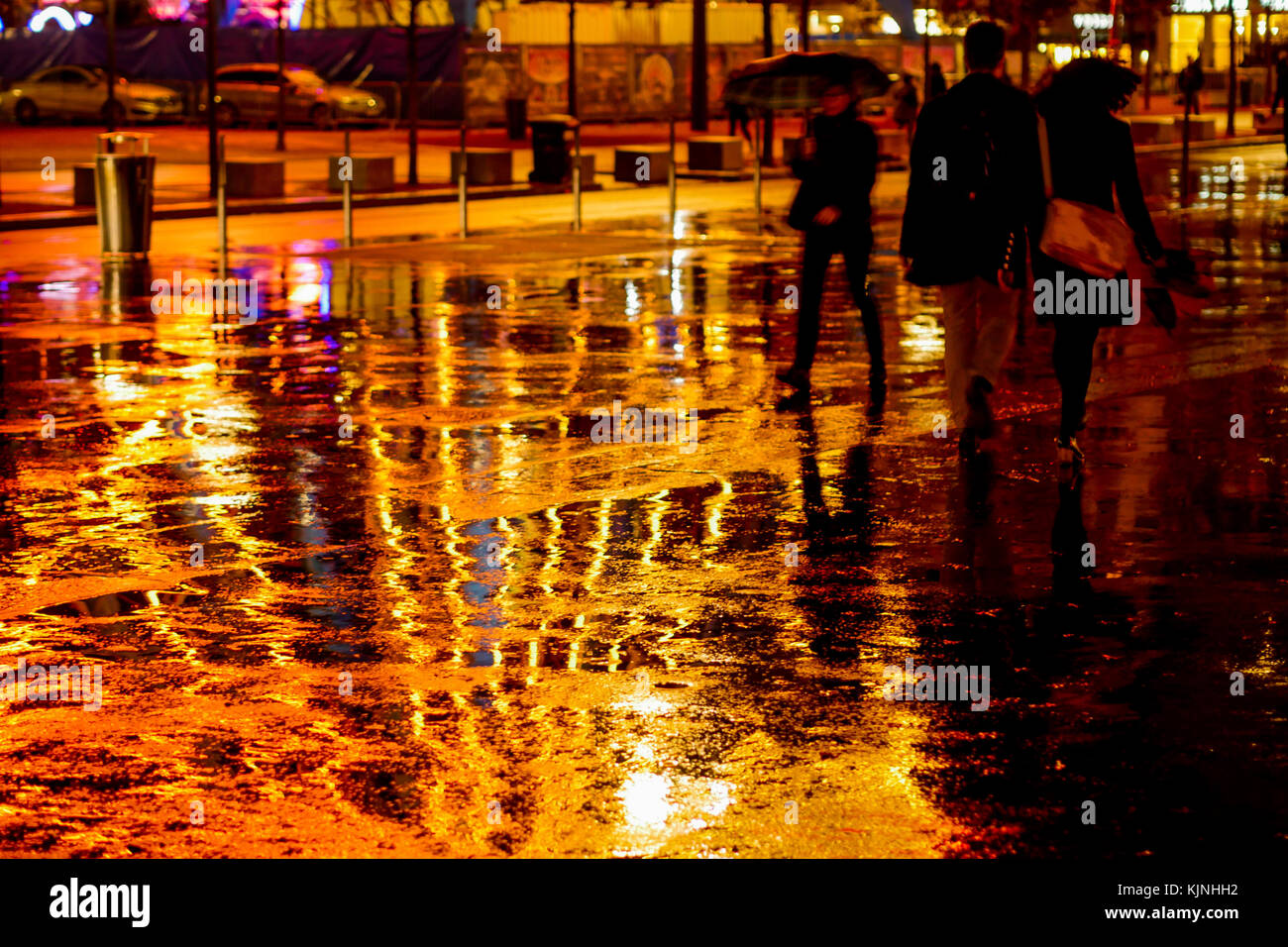 Traditional Ferris Wheel reflects on wet pavement, Lyon, France Stock ...