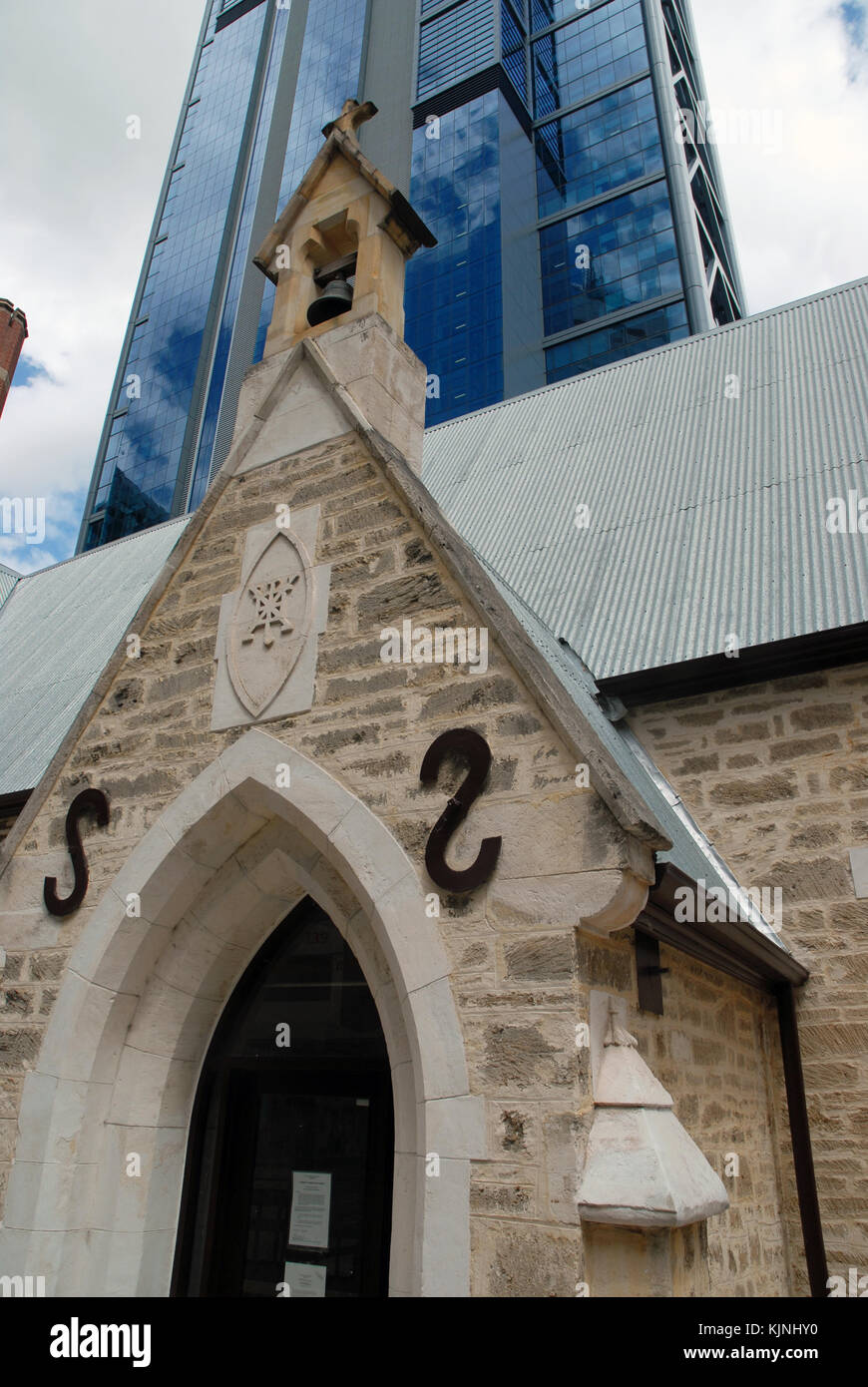 A modern high-rise office block behind the historic Perth Boys Grammar ...