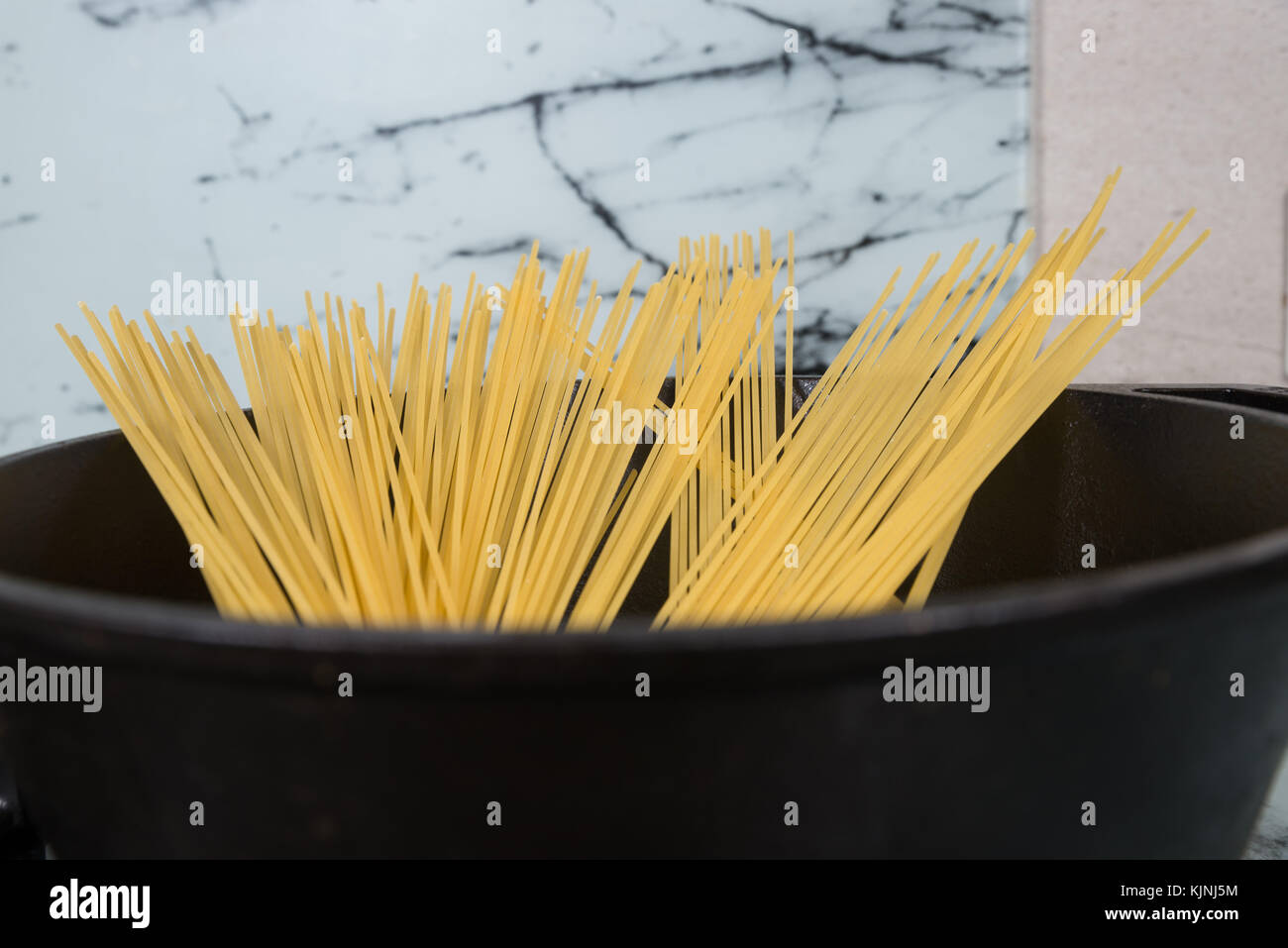 Pasta inside a pot ready to be cooked Stock Photo - Alamy