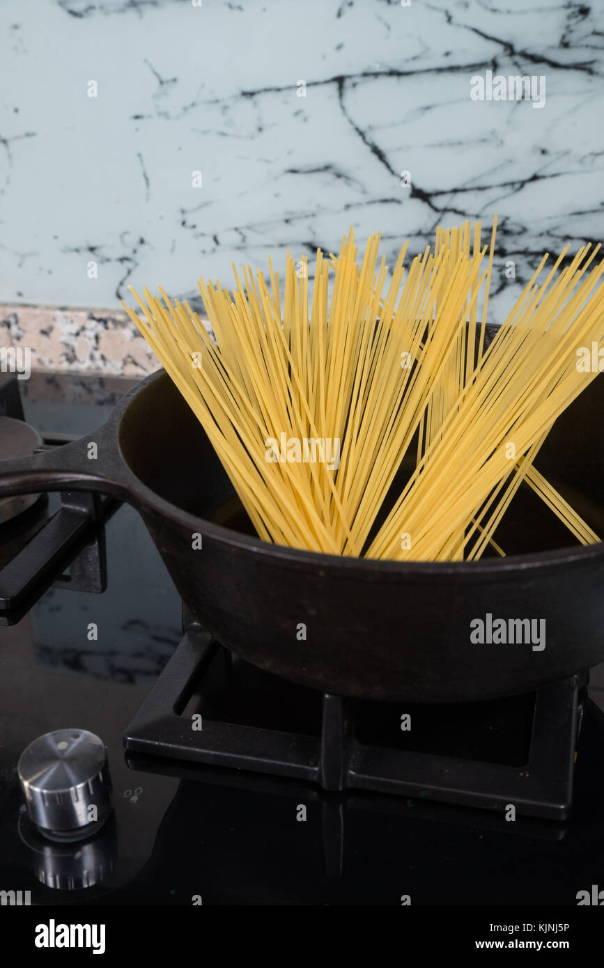 Pasta inside a pot ready to be cooked Stock Photo - Alamy