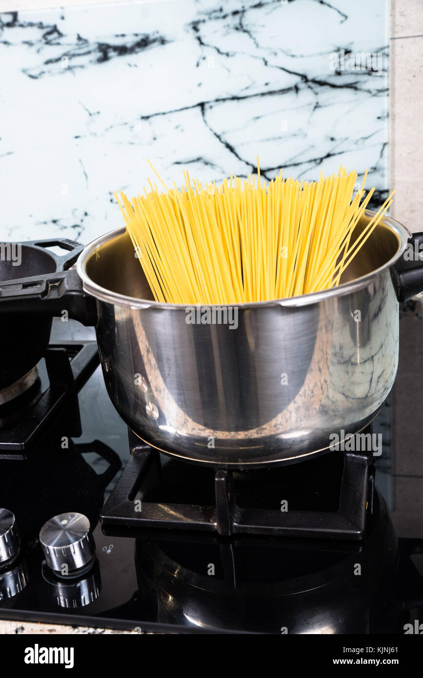 Pasta inside a pot ready to be cooked Stock Photo - Alamy