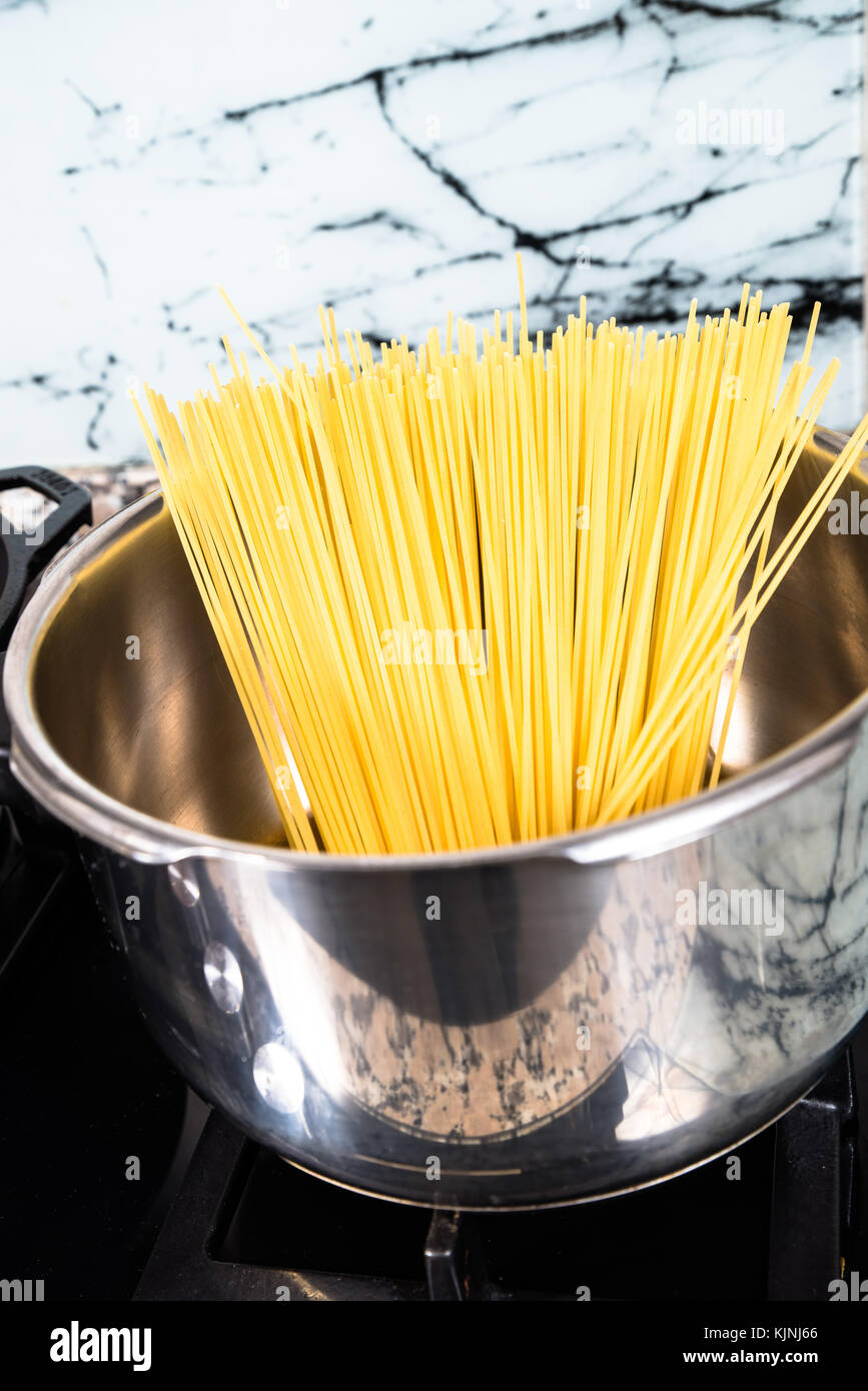 Pasta inside a pot ready to be cooked Stock Photo - Alamy