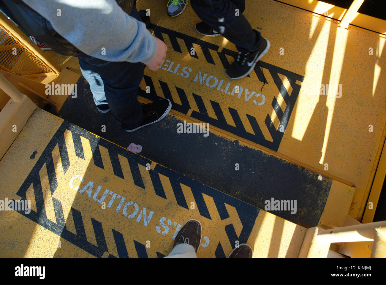 Caution sign on platform as passengers boarding a Swan River ferry at ...