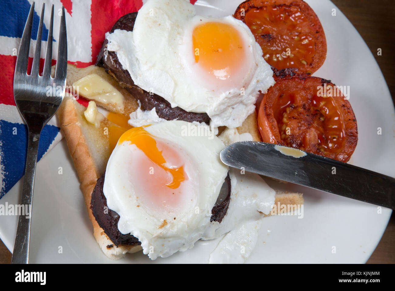 Simple English breakfast of Poached egg and Back pudding on toast with ...