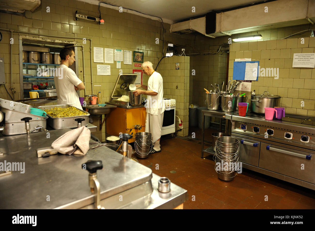 Two Hare Krishna cooks in a temple kitchen cooking for parishioners ...
