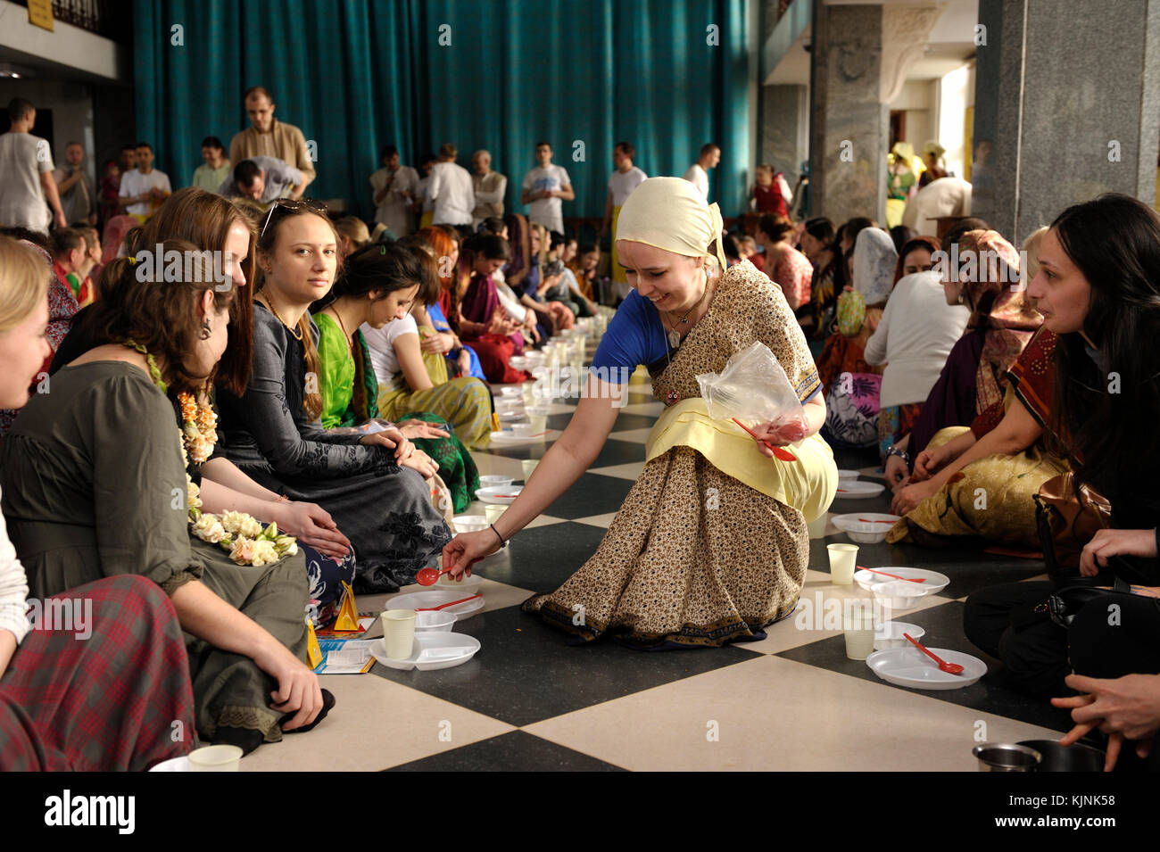 Attendants give to parishioners Prasad - food that is a religious ...