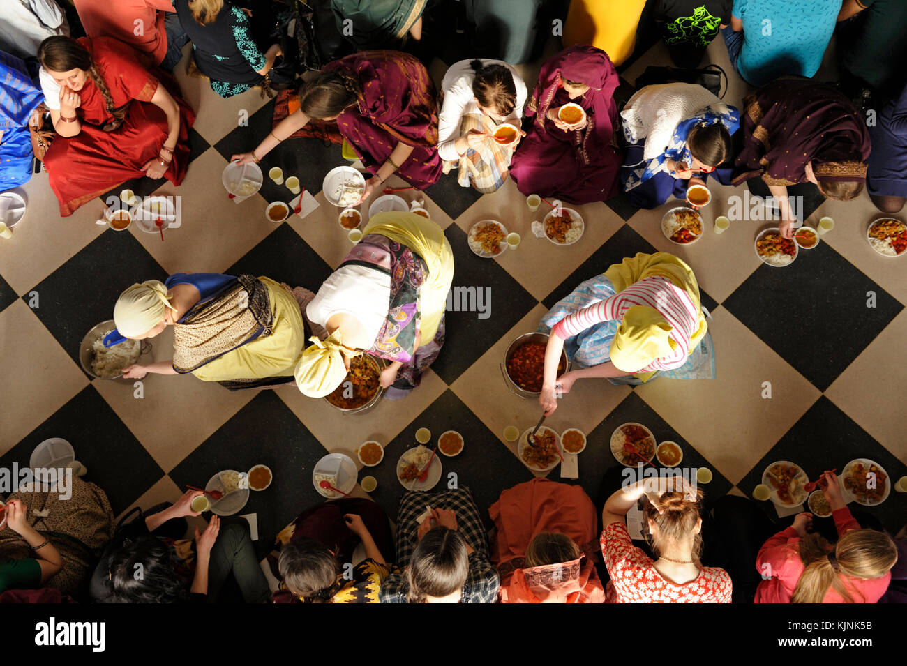 Attendants give to parishioners Prasad - food that is a religious ...