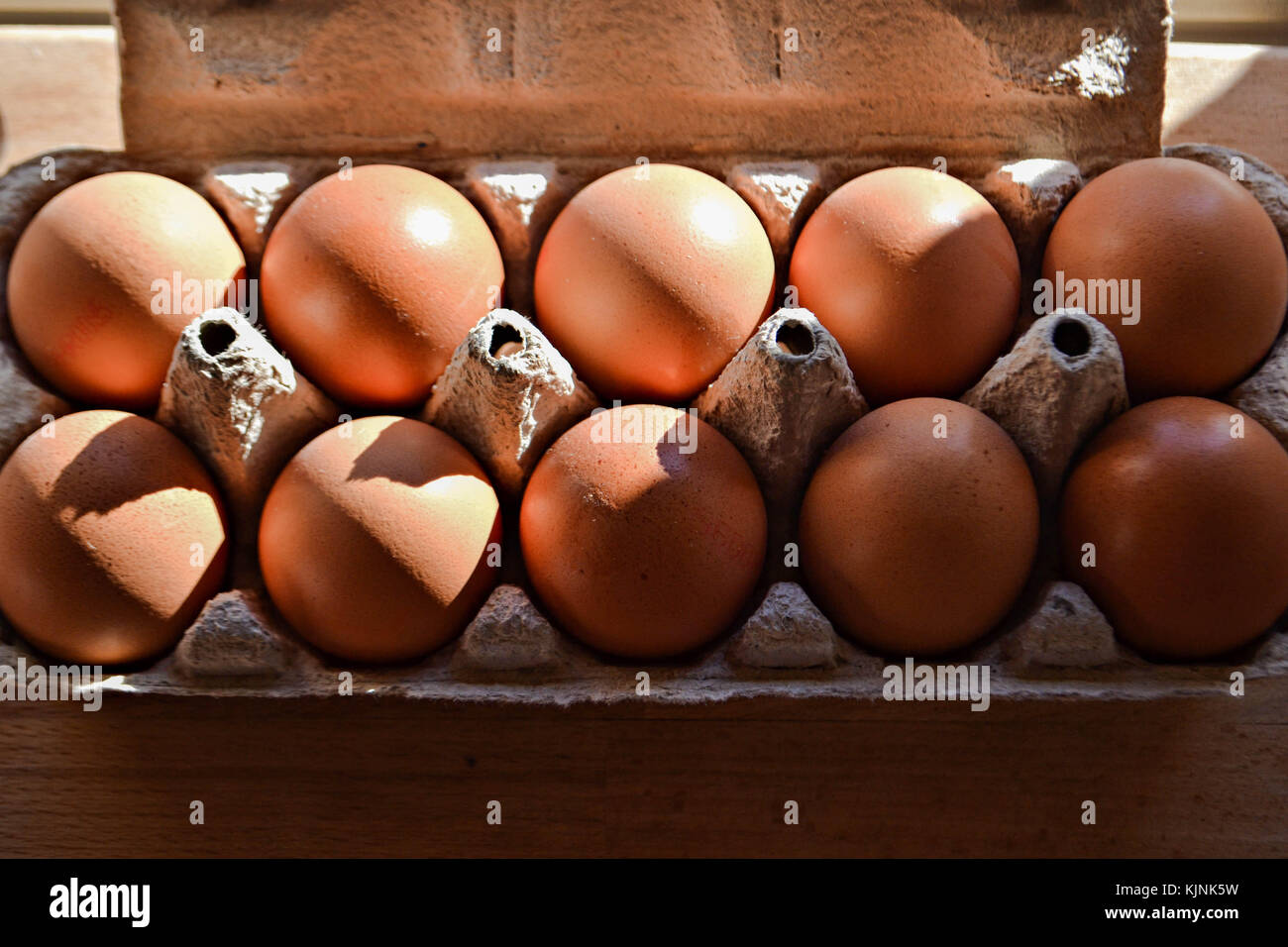 Packing eggs in a cardboard box on the table Stock Photo - Alamy