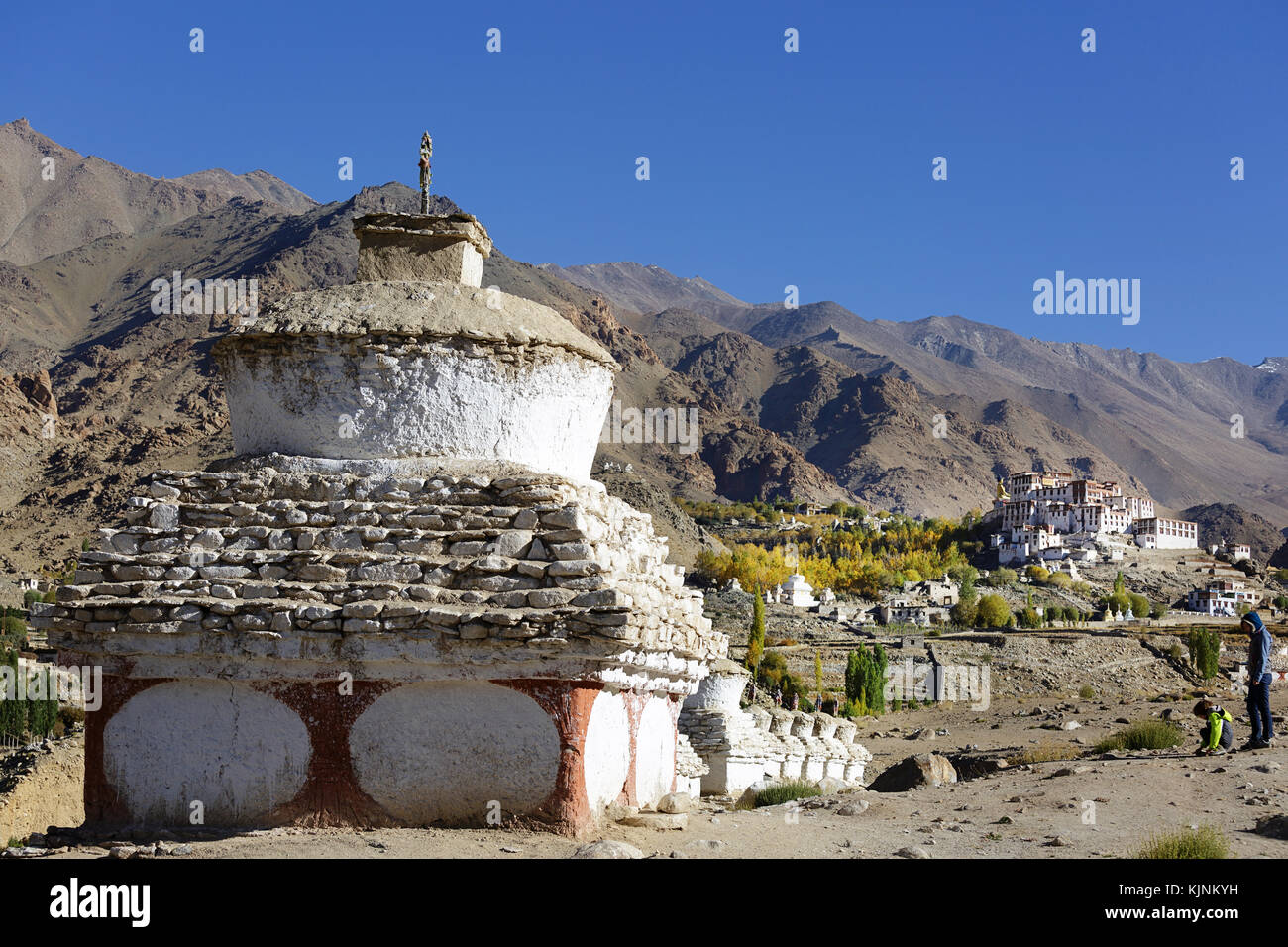 Young caucasian boy playing in front of a stupa with his mother, Likir ...