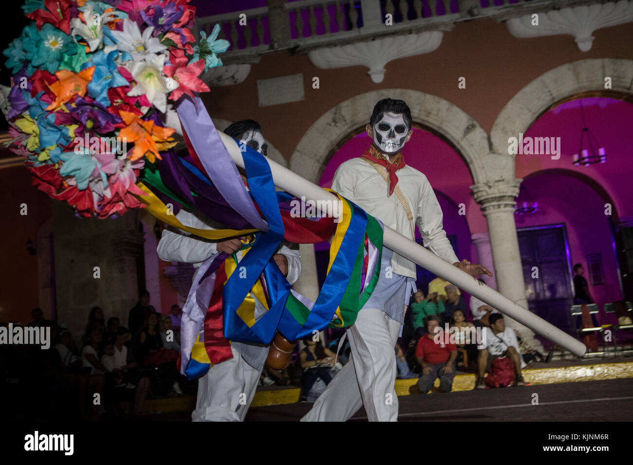 male dancer carrying the maypole wearing day of the dead face paint ...