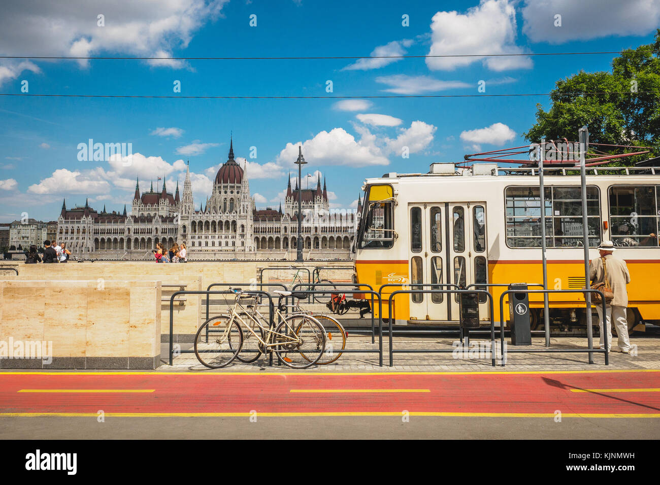 A view of the Hungarian Parliament Building with a yellow tram from the ...