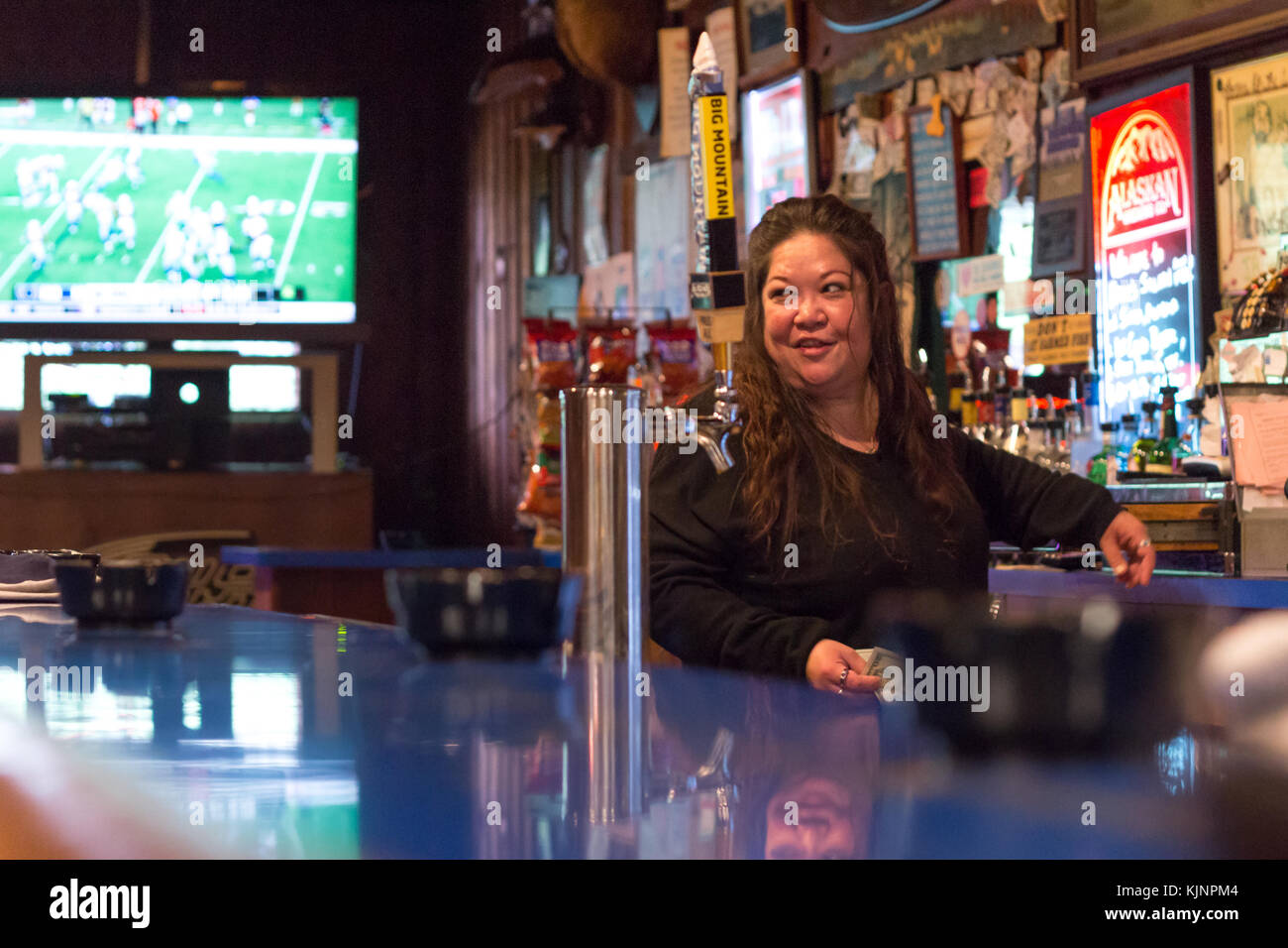 Sitka, Alaska, USA - August 20, 2017: A female bartender working at a ...