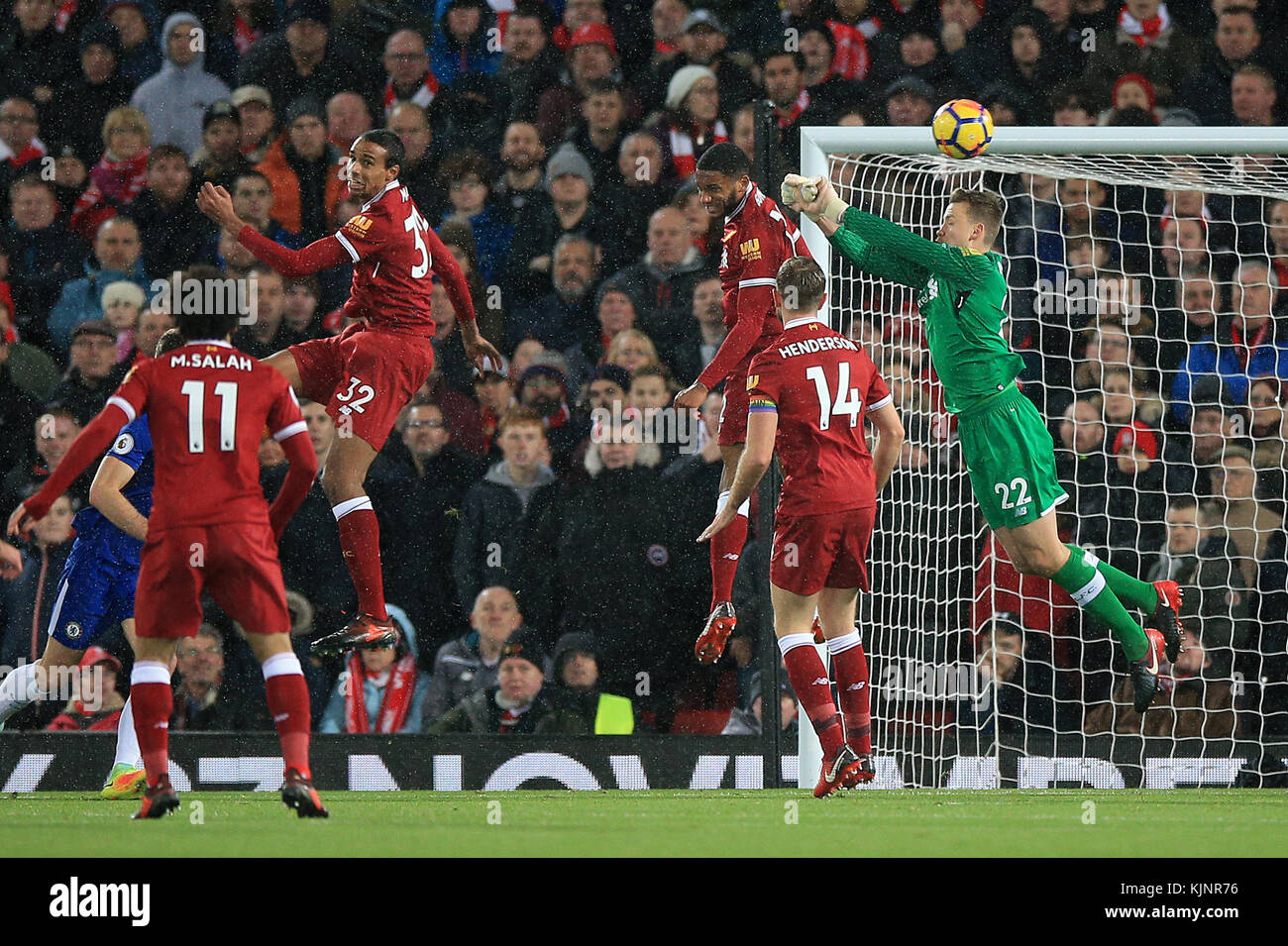 Liverpool goalkeeper Simon Mignolet (right) tries to punch the ball ...