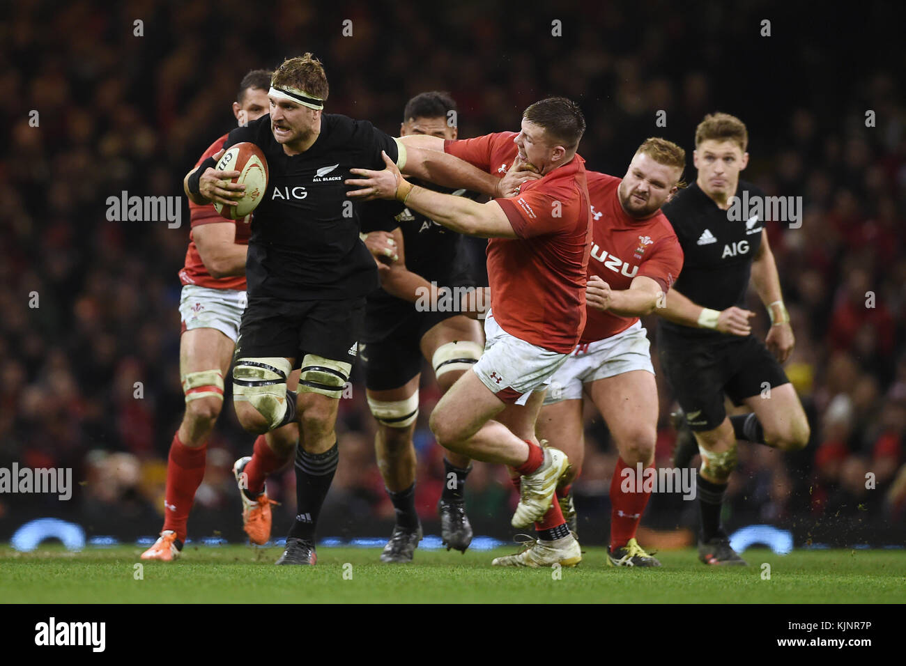 New Zealand's Luke Whitelock hands off Wales' Rob Evans (right) during ...