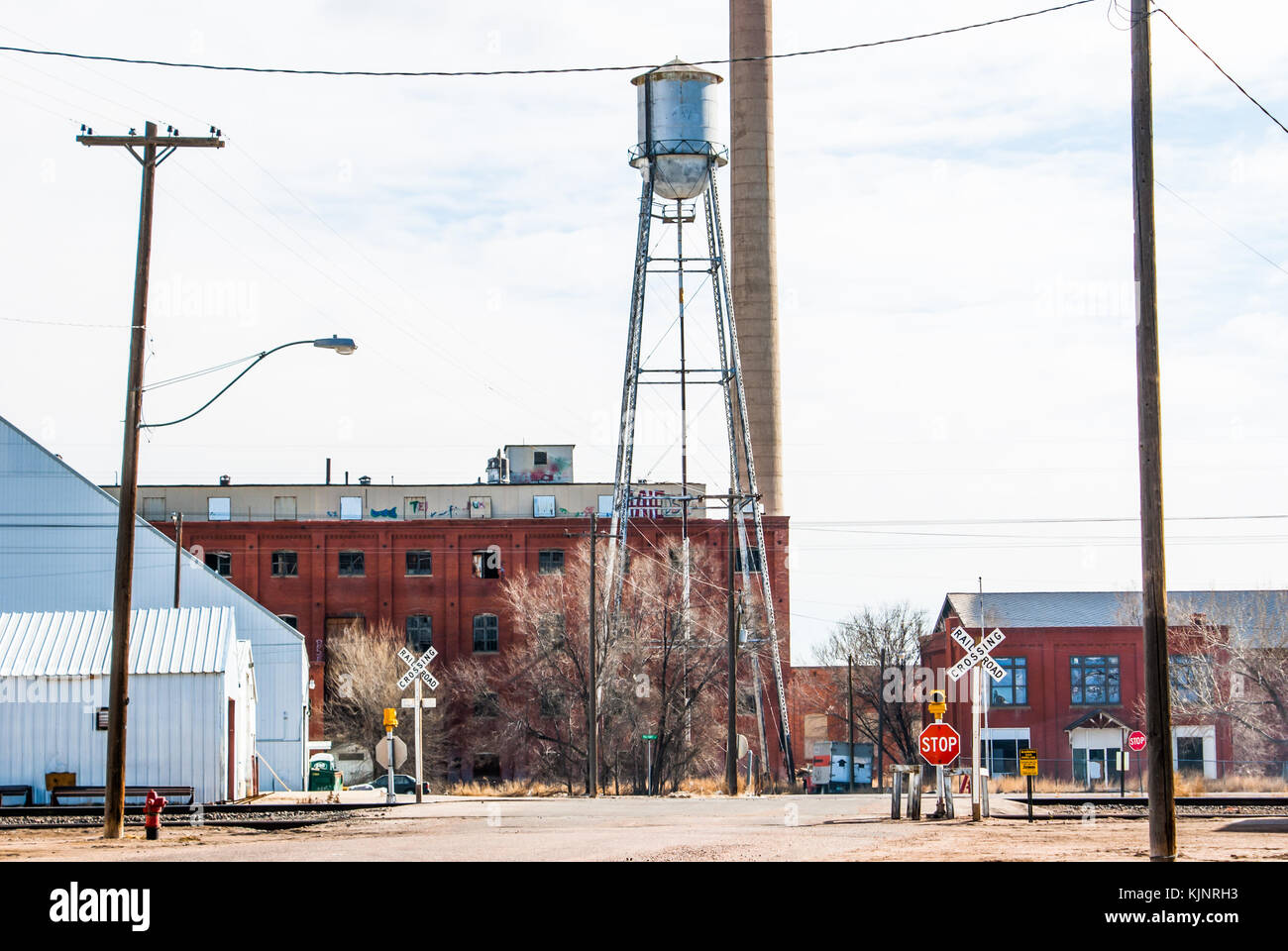 Old water tower and sugar mill behind a railroad crossing Stock Photo ...