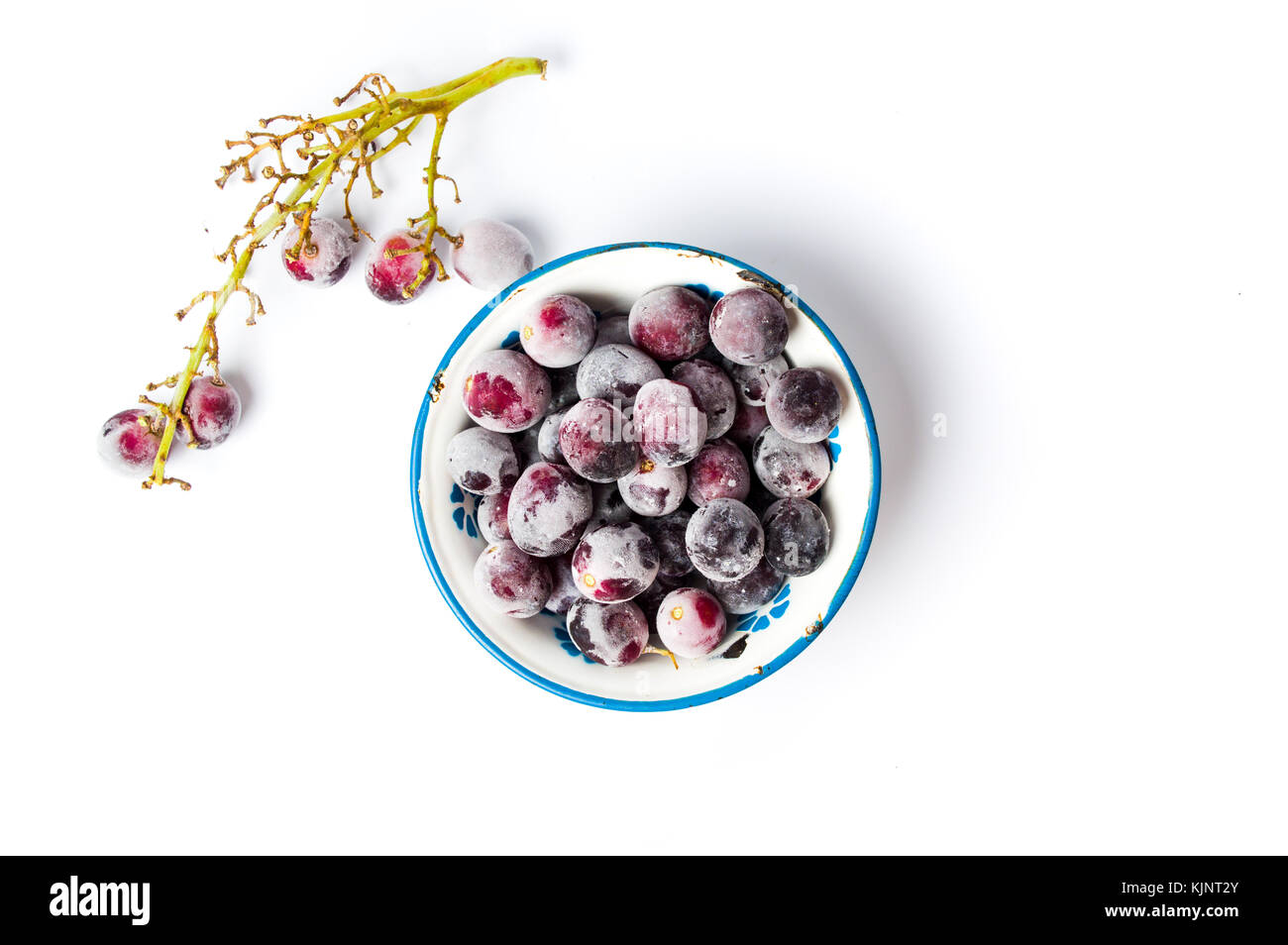 Frozen grapes cluster with ice on white background Stock Photo - Alamy