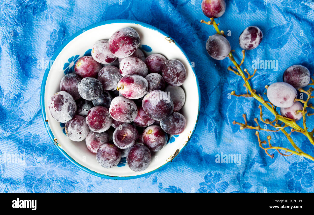 Frozen grapes cluster in the bowl tabletop shot Stock Photo - Alamy