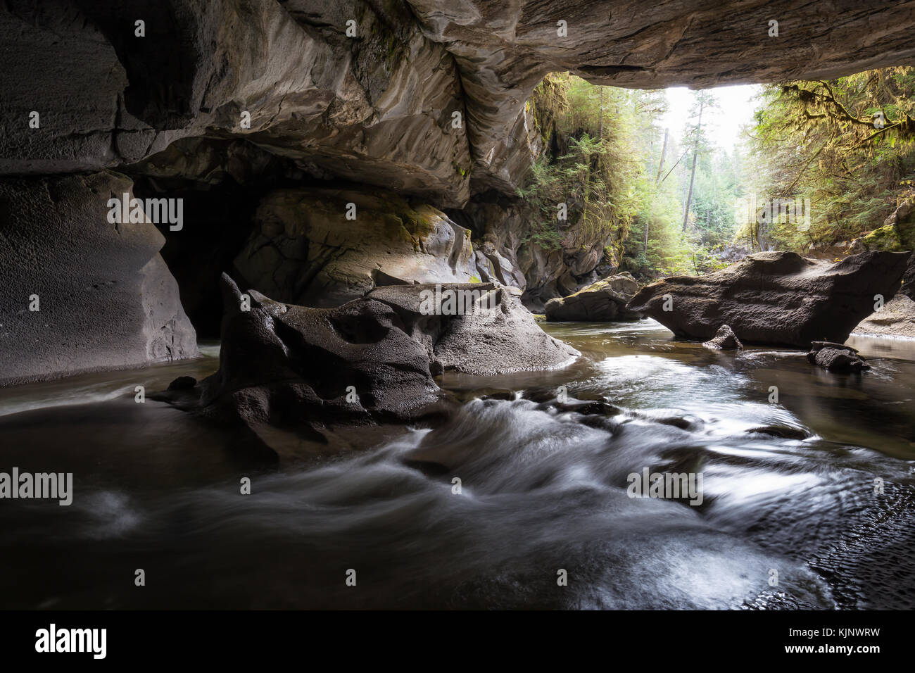 Beautiful natural river flowing into a cave. Taken in Huson Caves ...