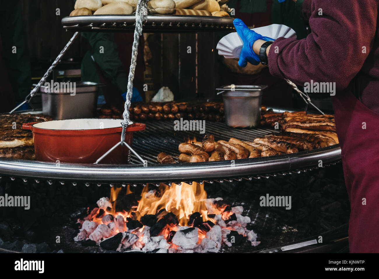 German sausages cooked on a large grill at an outdoor festival Stock ...