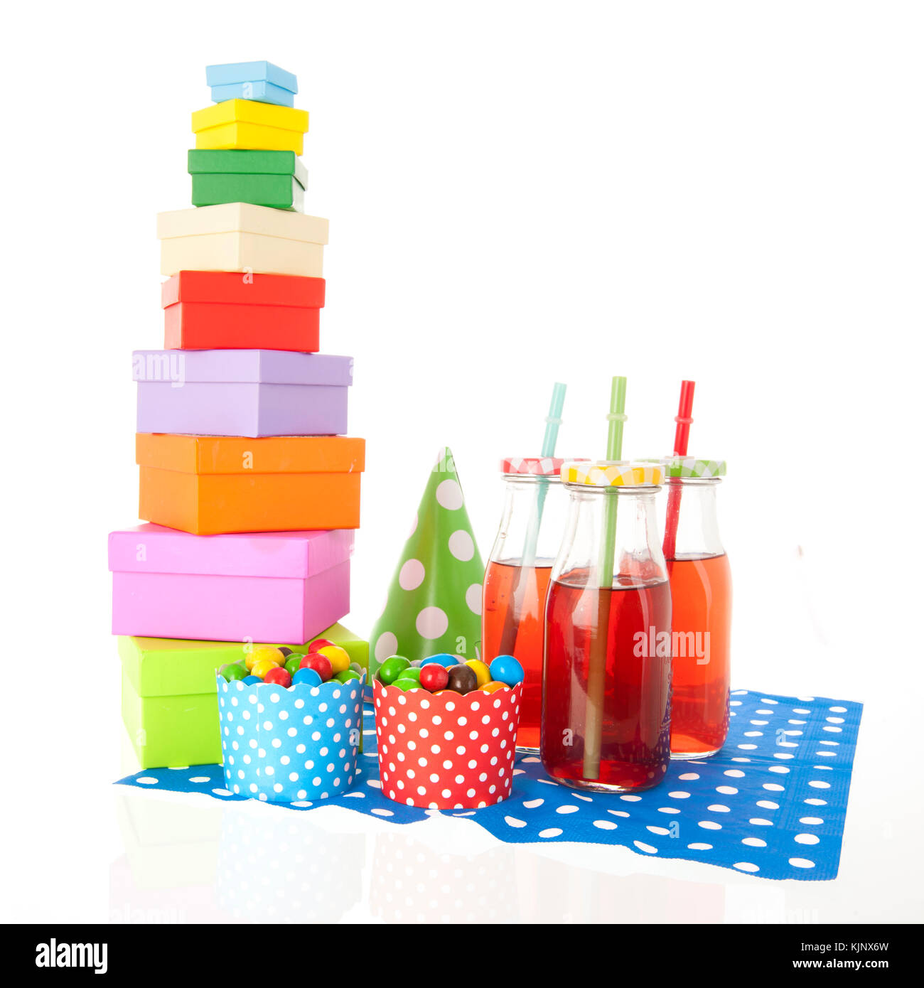 Stack birthday gifts and candy with party hats Stock Photo - Alamy
