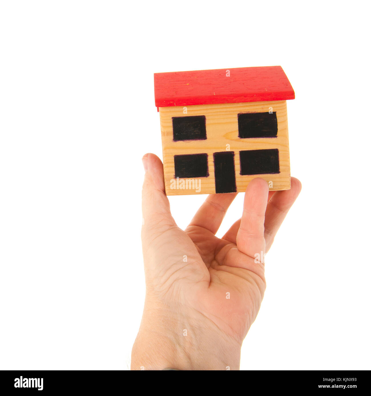 Wooden miniature house in hand isolated over white background Stock ...