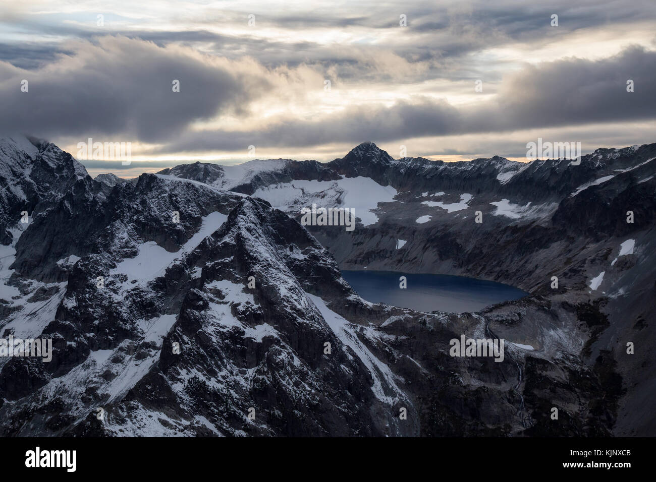 Aerial abstract landscape of the rugged mountains covered in clouds ...