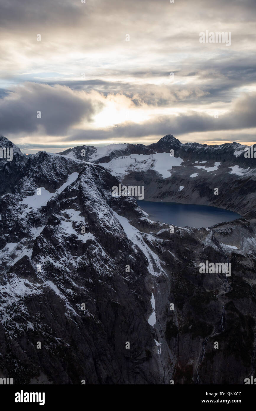 Aerial abstract landscape of the rugged mountains covered in clouds ...