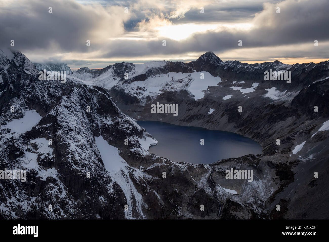 Aerial abstract landscape of the rugged mountains covered in clouds ...