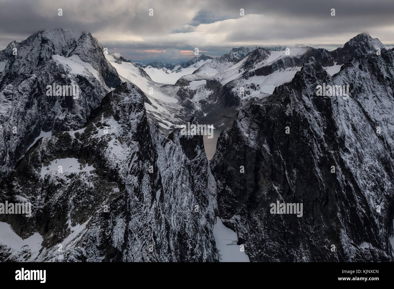 Aerial abstract landscape of the rugged mountains covered in clouds ...